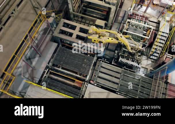 Robotic arm is moving bricks in a top view. Automatic robot arm working ...