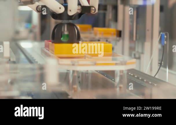 Details moving by probe arm on conveyor under scanner of automated ...