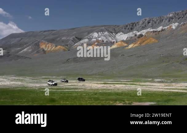 View of safari vehicle driving on sand tracks road. Aerial over off ...