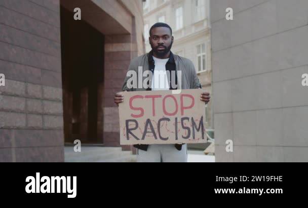 African american guy supporting anti racism campaign at city street ...