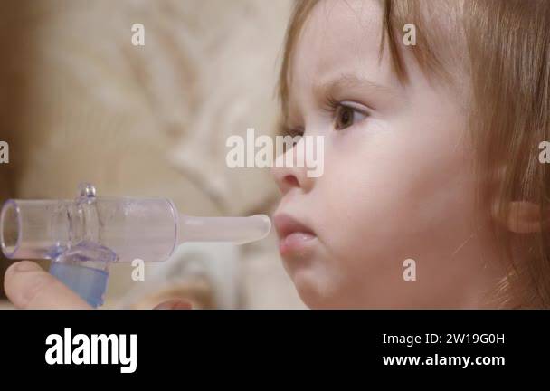 little girl treated with an inhalation mask on her face in a hospital ...
