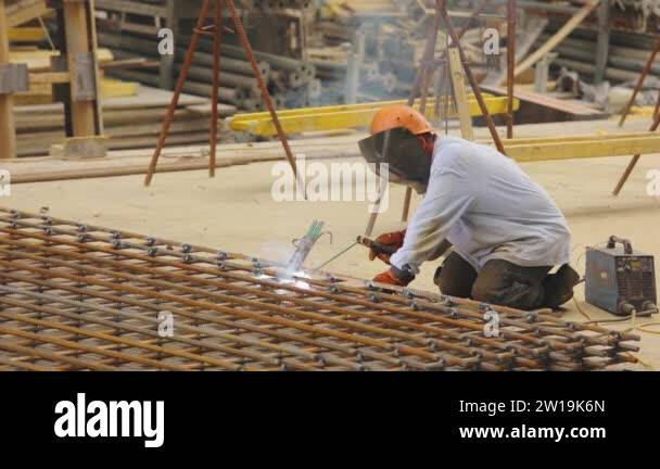 Steel Frame Construction. A welder welds a metal structure ...