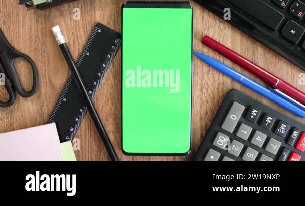 Green screen smartphone on the office table top view zooming in Stock ...