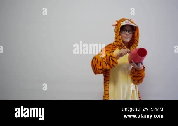 cute asian chinese musician girl playing the guiro. The güiro is ...