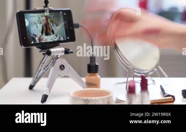 Beauty blogger woman filming makeup tutorial on camera, watching live ...