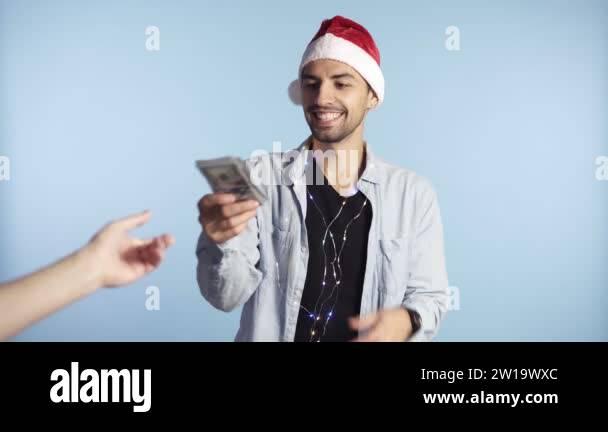 Young happy man received paper money, dollar banknotes. Counting money ...