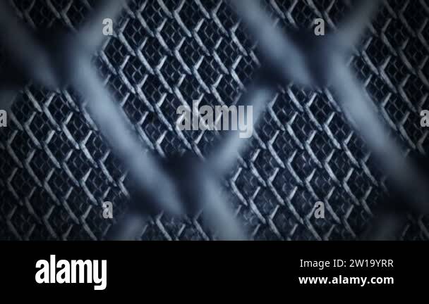 Metallic wire fence on a dark background. Chain of wire mesh steel ...