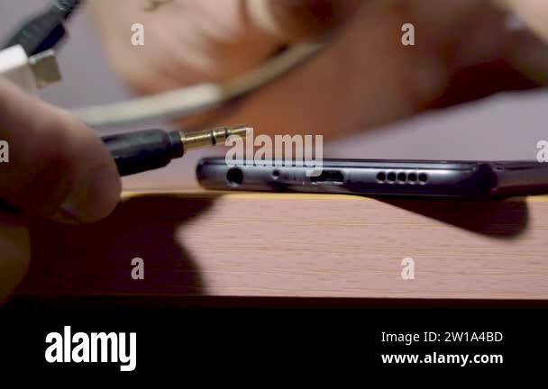 Insert and pull out the plug of the audio jack smartphone. Connecting ...