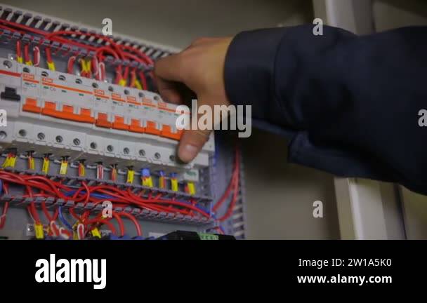 Trip Switch Fuse box. Man hands turning on all switches in a ...