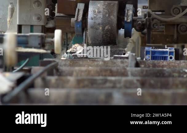 Sawing machine at wood production factory. Timber material processing ...