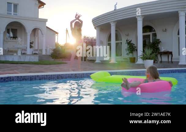sweet child in Inflatable ring swim in pool In sunlight, Little girl In ...