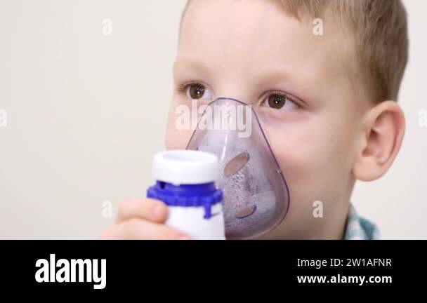 Toddler breathes with an inhaler with mask. Treatment of chronic lung ...