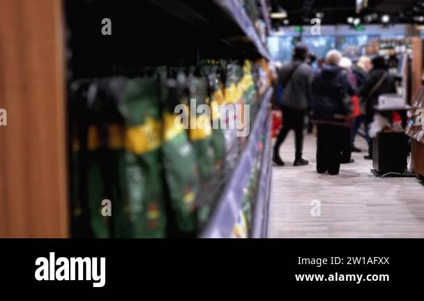 Rows and Shelves with Various Goods in the Supermarket. Buyers Choose ...