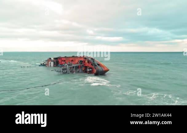 cargo ship a tanker ran aground and rolled over into the sea with waves ...