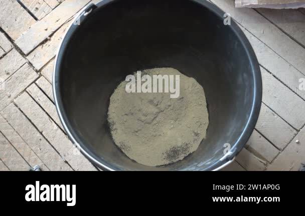 The builder masonry trowel the dry construction mixture into the vessel ...