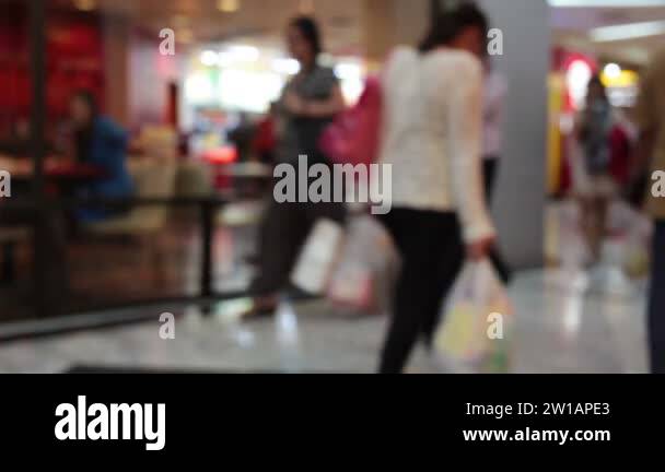 abstract blur background of shopping mall and crowd of walking people ...