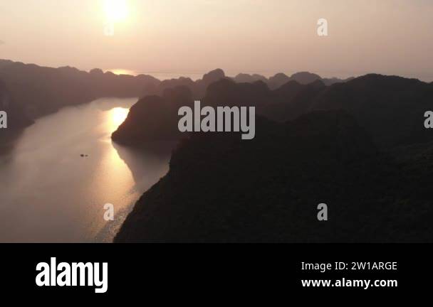 Aerial: unique flying over Ha Long Bay and Cat Ba island at sunset ...