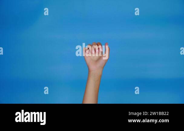 Female hand counting from 5 to 1 on blue background with copy space ...