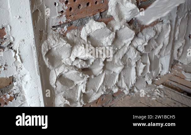 Plaster builder applies plaster layer to brick wall,Repair and ...