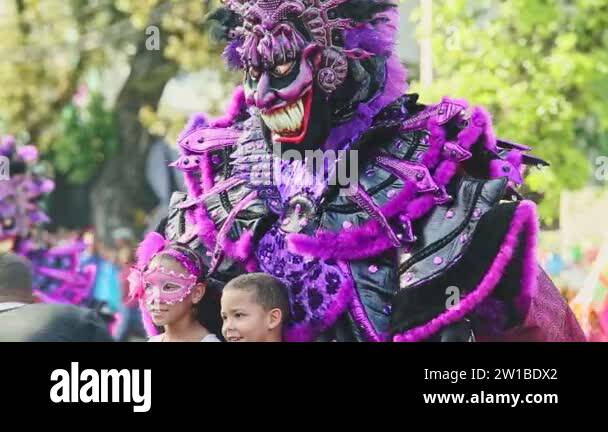 people take photos with costumed demons on dominican city street at ...
