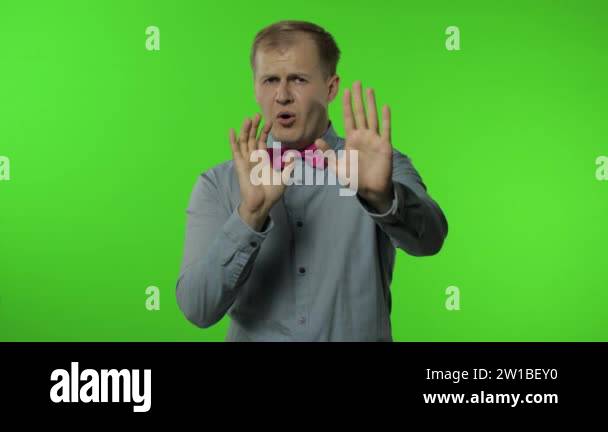 Scared man with his own phobia, raising hands, panicking afraid to look ...