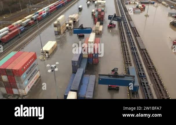 Work loaders at the railway cargo terminal. Visible freight containers ...