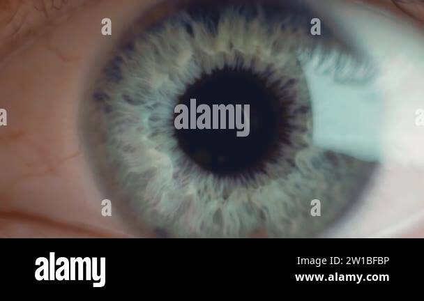 Extra macro shot of mans opening eye with blue iris and big black ...