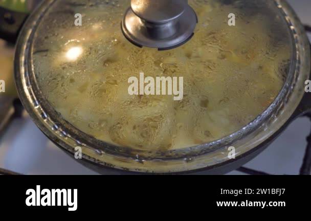 Condensation on the glass lid when cooking. Stewed potatoes with onions ...