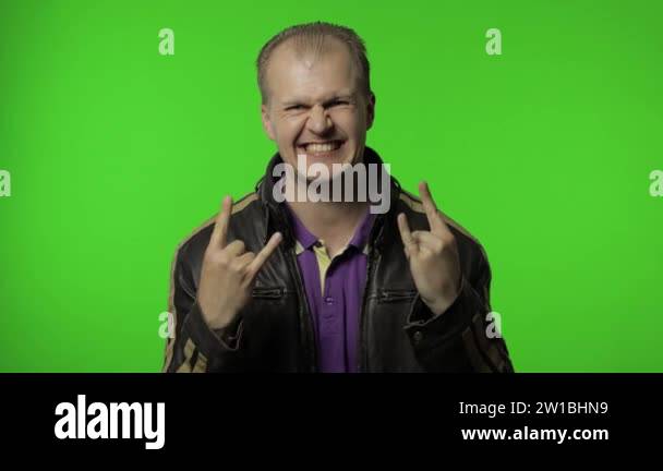 Rocker man showing rock and roll sign, devil horns gesture, looking ...