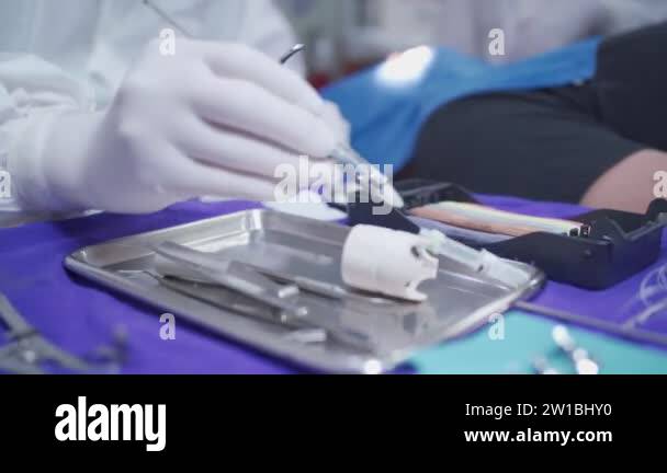 Doctor Dentist inserting medical needles while working on male patient ...