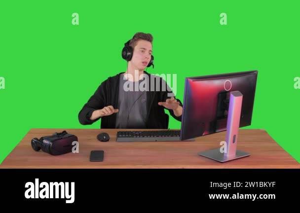 Gamer playing a game and losing on a Green Screen, Chroma Key Stock ...