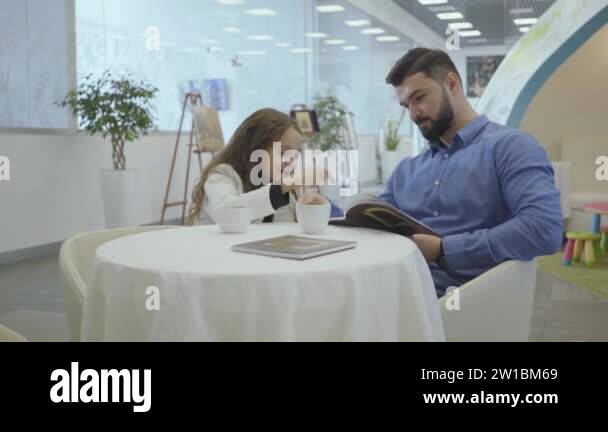 Rich Caucasian man and little girl sitting at the airport VIP waiting ...