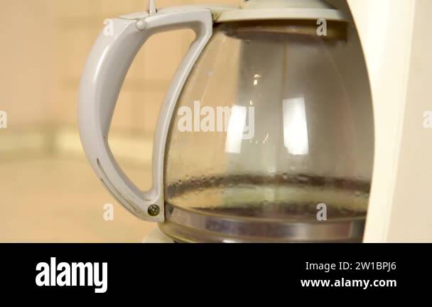 Coffee is brewed in a coffee maker. Coffee dripping into a flask with a ...