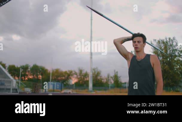 A male athlete throws javelins at a stadium in slow motion. Athletics ...