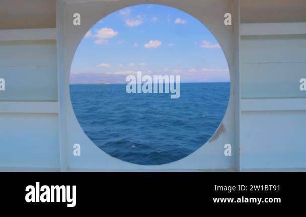 Summer seascape from round window of the yacht. Water transport. Travel ...