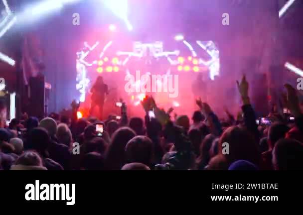 concert party, crowd of fans jumping into rhythm at rock festival with ...