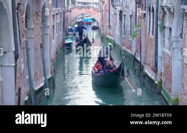 Navigating Venice's Canal stock footage features tourists on a gondola ...