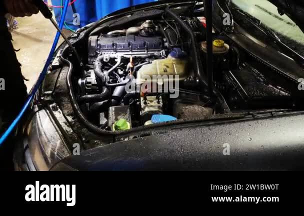 Self service car wash. Man washing his car at automobile washing ...