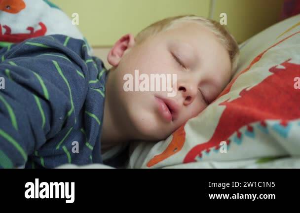 The boy tossing and turning in her sleep, Sleeps with his mouth open ...