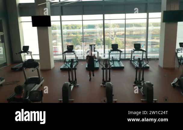 The man saying goodbye to his friends after running on a treadmill and ...