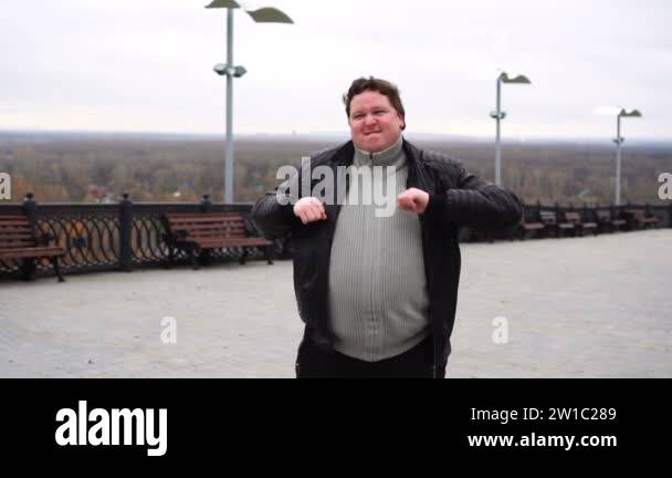 Zoom in portrait of fat man with big belly is dancing outdoor Stock ...