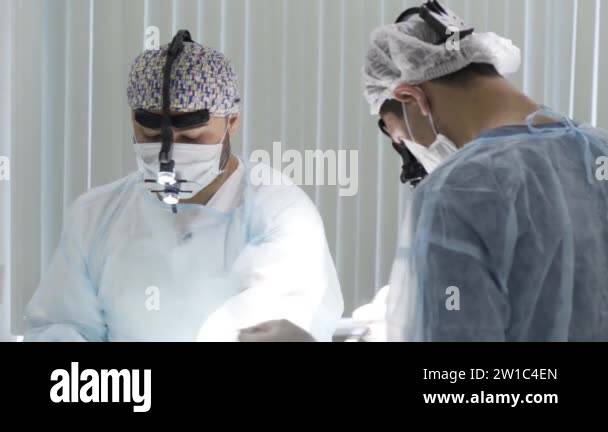 The medical surgeons team in the hospital performing surgical operation ...