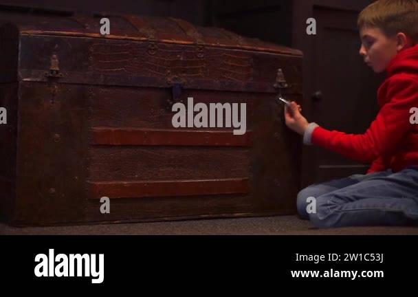 a boy at a school competition opens a combination lock on a chest Stock ...
