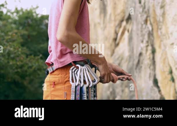 Rock climbing detail of climber harness with gear and hands grabbing ...