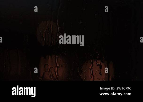 Close-up of drops on glass background of bokeh lights. Concept. Through ...