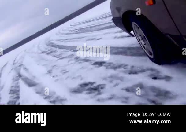 Drift on the ice of the lake at high speed. View of the front wheel of ...