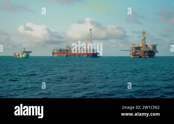 FPSO tanker vessel near Oil Rig platform. Offshore oil and gas industry ...