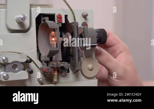 Man launches old vintage film projector with tape to arrange movie ...