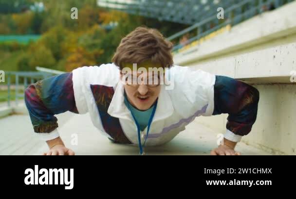 Close up of funny old-fashioned male athlete in big glasses doing push ...