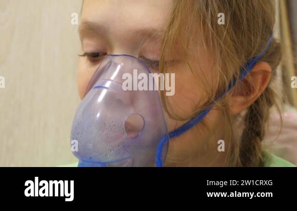 The child is sick and breathes through an inhaler. close-up. little ...